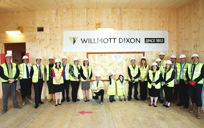 Wall signing signals key milestone for school extensions | Willmott Dixon
